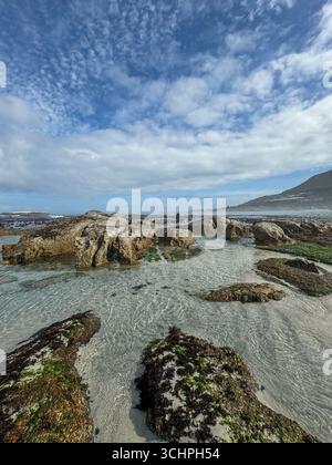 A low angle shot of a rocky mountain under a blue sky in winter Stock ...