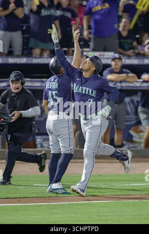 Seattle Mariners' Jorge Polanco, right, celebrates his RBI base hit ...