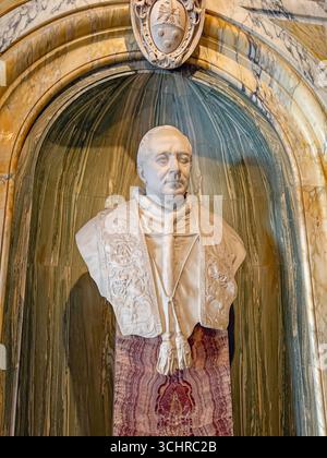 Marble statue of Pope Pius XI holding a cross and raising his right ...