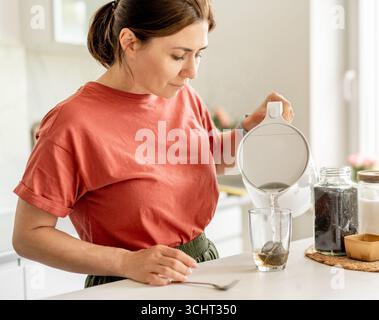A woman making a tea blend Stock Photo - Alamy