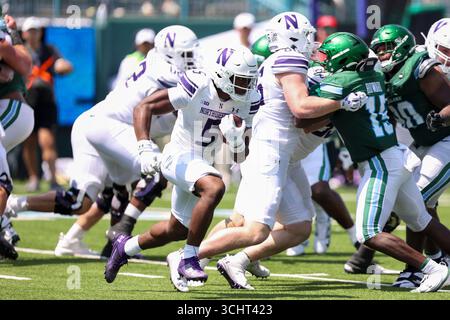Northwestern running back Caleb Komolafe, left, catches a pass as ...