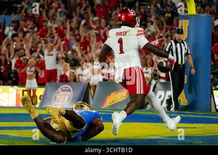 Utah running back Wayshawn Parker (1) is chased by Kansas safety Lyrik ...