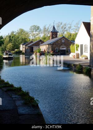 Beautiful canalside buildings with a tower and a narrowboat, near Tring ...
