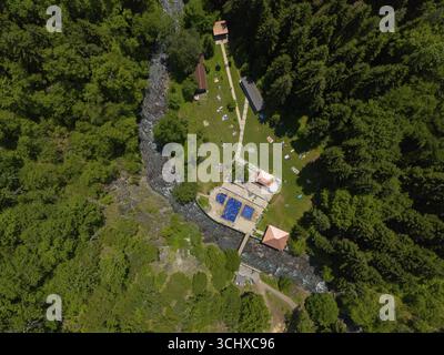 An aerial view of building surrounded by dense trees Stock Photo - Alamy
