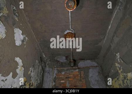 equipment, wiring and pipes in an abandoned underground bunker, shabby ...