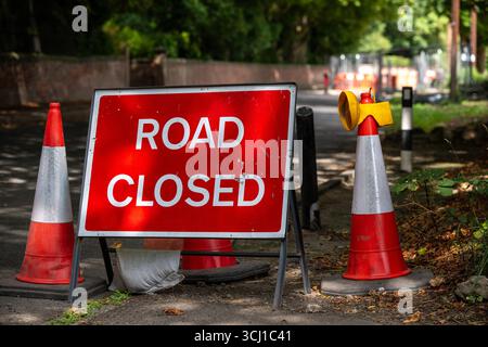 red road closed sign with cones and barrier Stock Photo - Alamy