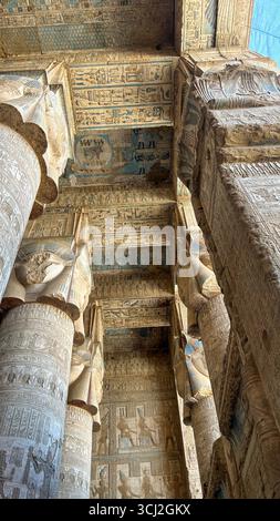 Ancient hieroglyphs and carved columns with painted ceiling details ...