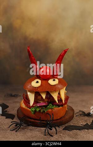 Halloween food concept. Scary hamburgers with fresh lettuce, tomatoes ...