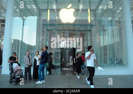 People exit an Apple store on Fifth Avenue in Manhattan, New York City ...