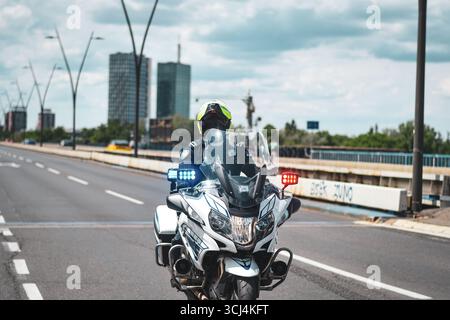 Police motorcycle officer leading motorcade on city street Stock Photo ...