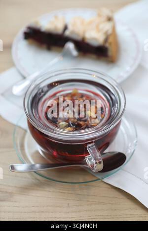 Cup of tea and small toast bread with jam on old wooden background, top ...
