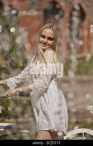 Photo portrait of pretty girl smiling amazed hands on chest wearing ...