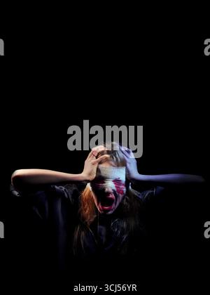 Scared bloody girl screaming on black background with copyspace Stock ...
