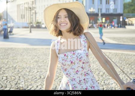 cute young woman at sunny street in european city smiling, looking at ...