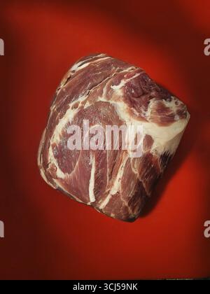 large piece of raw red meat in the industrial freezer of the butcher's ...
