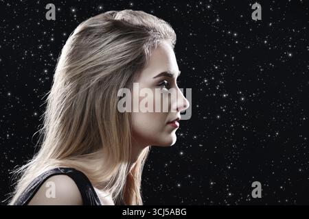sad female profile silhouette on stars background with copy space ...