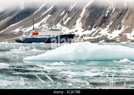A boat navigates through the ice-covered Moskva River during heavy ...