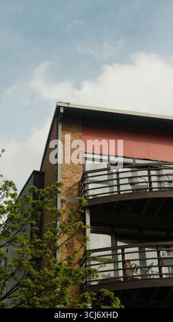 Modern balcony railing design with cloudy sky backdrop Stock Photo - Alamy