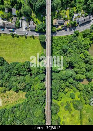 A bridge over a river with trees alongside Stock Photo - Alamy
