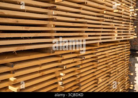 Neatly stacked wooden planks for construction or artistic projects ...