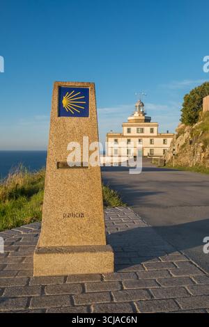 End of Saint James Way sign and lighthouse of Finisterre in Galicia ...