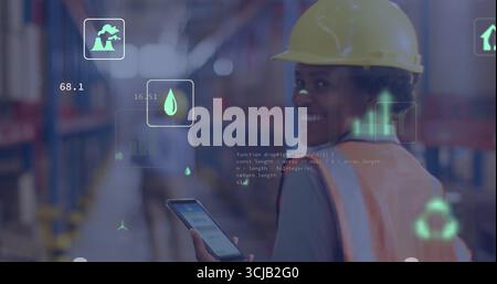 Scanning woman in hard hat and vest, operating handheld barcode scanner ...