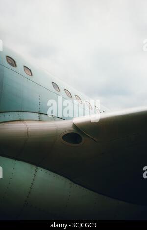 Detailed view of commercial passenger airplane wing with open spoilers ...