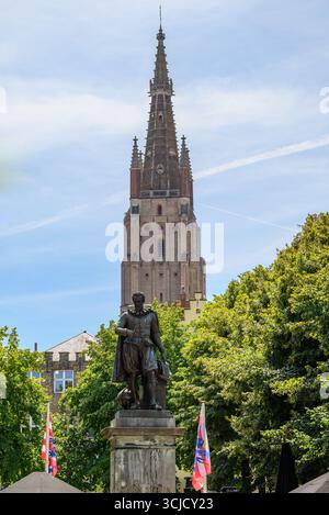 Statue of Simon Stevin by the cathedral tower in the city of Bruges ...