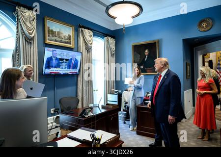 President Donald Trump, right, watches as retired Marine Maj. James ...