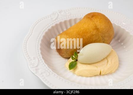 Elegant serving of Neapolitan rum baba dessert with creamy custard and ...