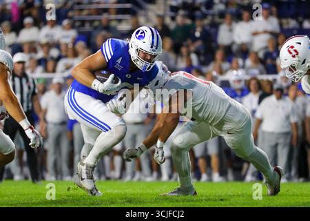 BYU tight end Carsen Ryan, front left, prepares to be hit by East ...