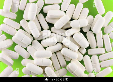 Calcium supplement pills piled on metal spoon closeup Stock Photo - Alamy