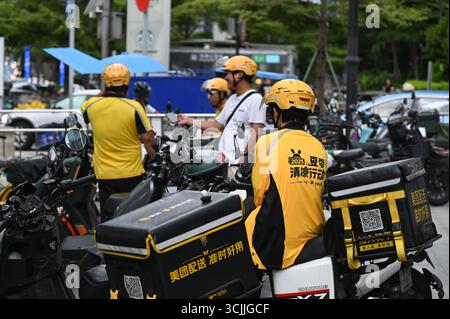 A general view showing the a Meituan delivery driver waiting the order ...