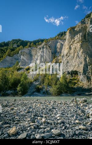 A flowing river surrounded by dense autumn trees Stock Photo - Alamy