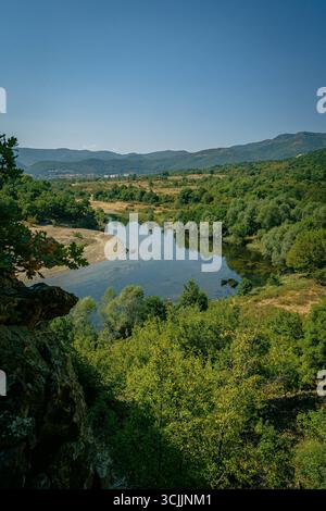Curving river through autumn forest with colorful trees, calm water ...