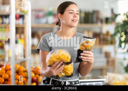 European youth girl choose and buy pizza with filling in store Stock ...