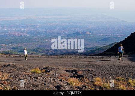family hikes to the craters of the volcano Etna early in the morning ...