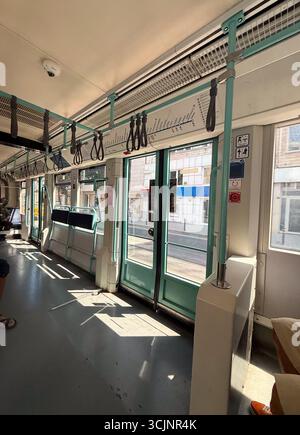 Interior of modern tram with doors and handles. Public transport ...