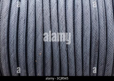 Steel cable wound on a reel, close-up. The texture of the steel cable ...