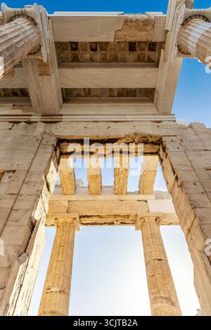Looking up at a columns of Propylaea gateway in Acropolis of Athens ...