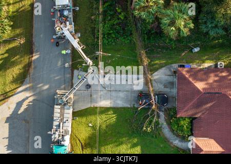 Electrician workers repairing damaged power lines using bucket trucks ...