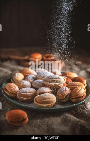 Sweet walnut shaped cookies with boiled condensed milk on yellow ...