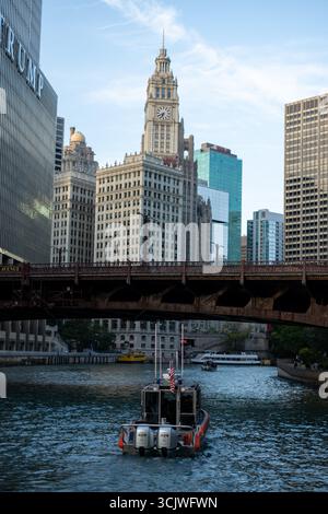 US Coast Guard boat patrols the Chicago River, framed by Trump Tower ...