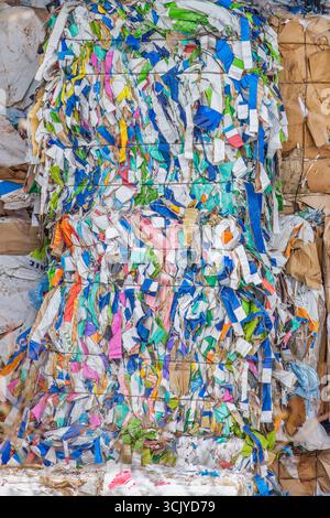 Bundle of colorful wastepaper cardboard to be recycled. Paper cardboard ...