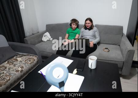 Engaging study session between a mother and daughter at home Stock ...