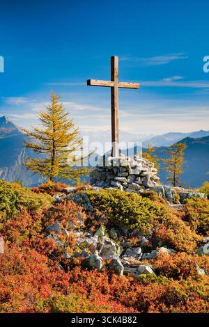 Mountain cross, view of the Lower Valais with autumn forest, Alpage de ...
