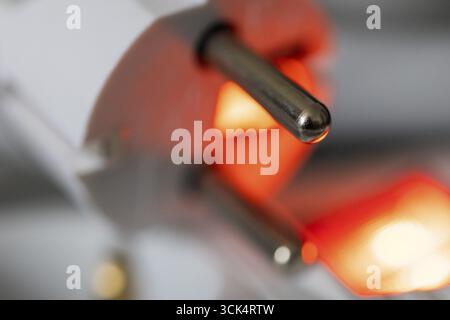 White power plug, Schuko plug is illuminated red by the red indicator ...