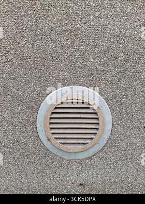 Metal pipe outlet on machinery surface representing industrial ...