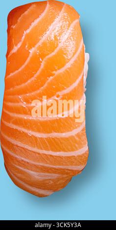Vibrant orange salmon fillet on white ceramic plate with fresh green ...