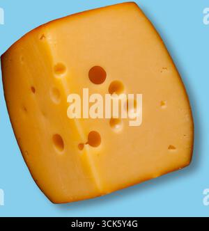 Sliced delicious edam cheese set, in plastic pack, on black wooden ...